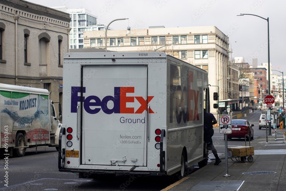 Portland, OR, USA - Jan 26, 2022: A FedEx Ground driver unloads his van ...