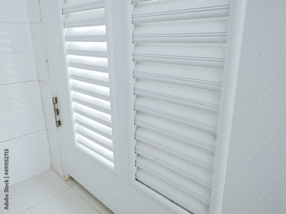 White bathroom door vent in the modern bathroom. Stock Photo | Adobe Stock