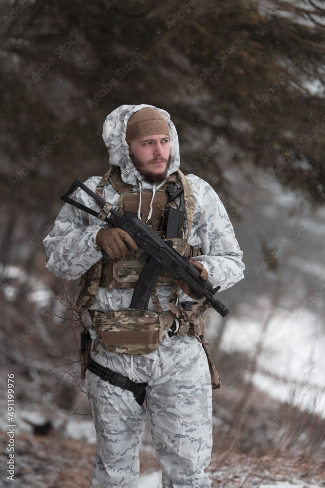 Soldier in winter camouflaged uniform in Modern warfare army on a snow ...