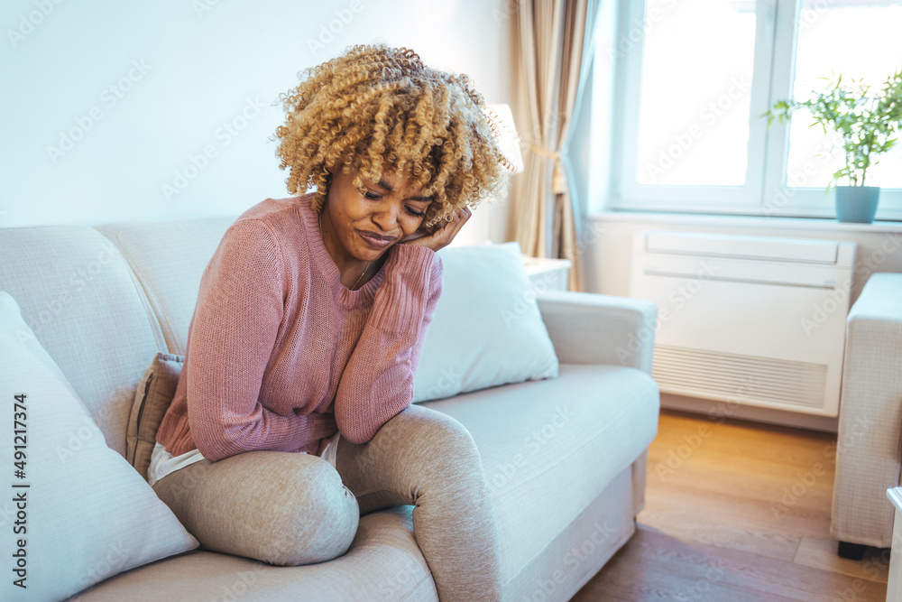 Young sick african american woman with hands holding pressing her ...