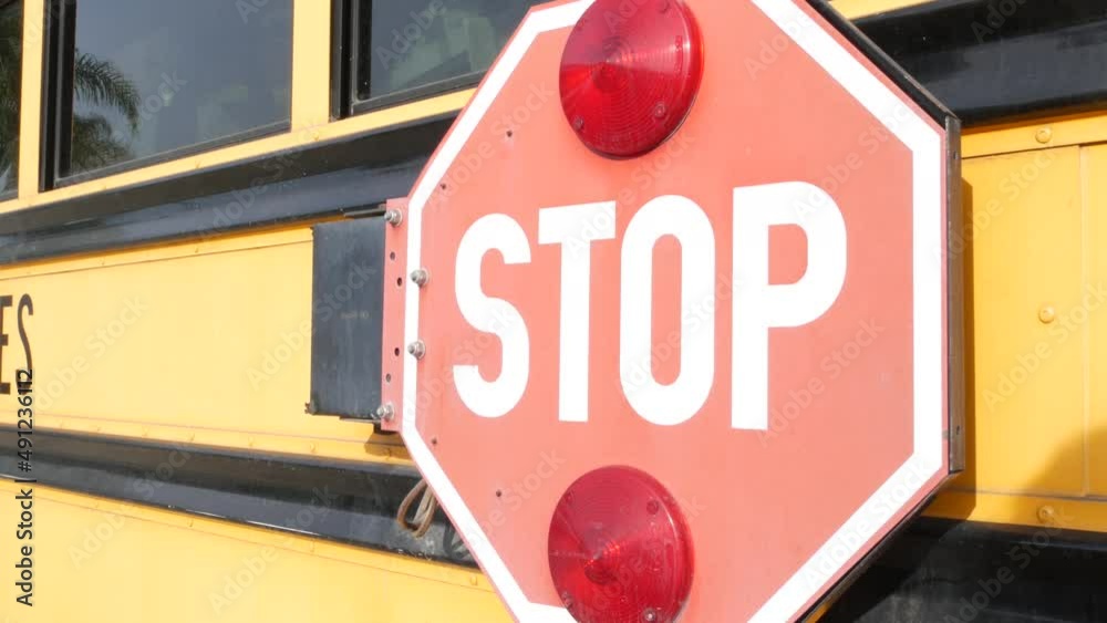Red stop sign, yellow school bus in California, USA. Traffic warning on ...
