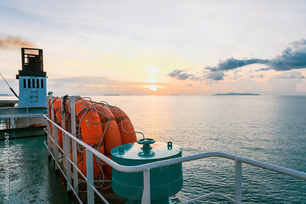 Orange inflatable lifeboats on ferry deck for emergencies and maritime ...