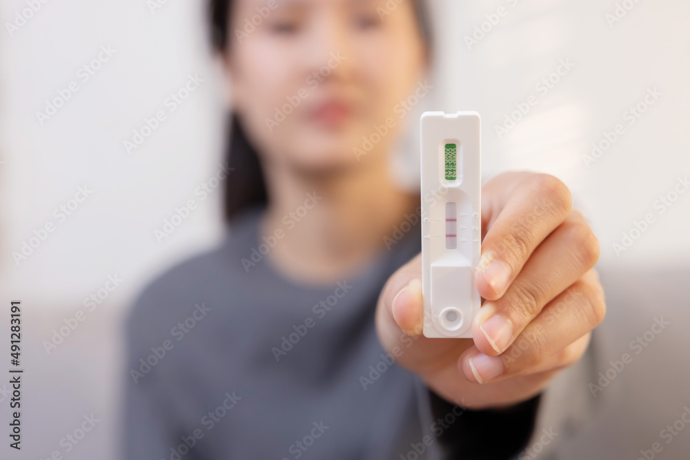 Woman Hand with ATK Antigen Test Kit Strip with Positive Result of ...