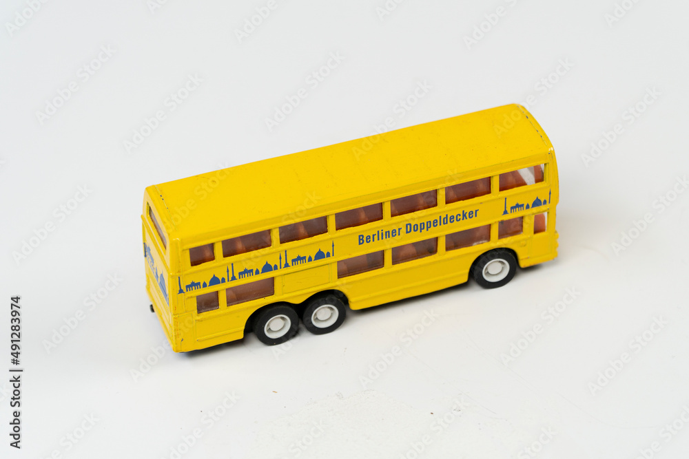 Miniature yellow double decker metal bus isolated on white background ...
