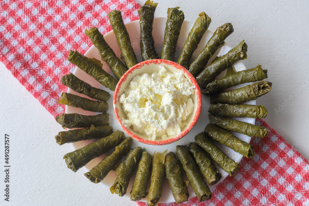 Delicious dolma (sarma) stuffed grape leaves rice, white yogurt sauce ...