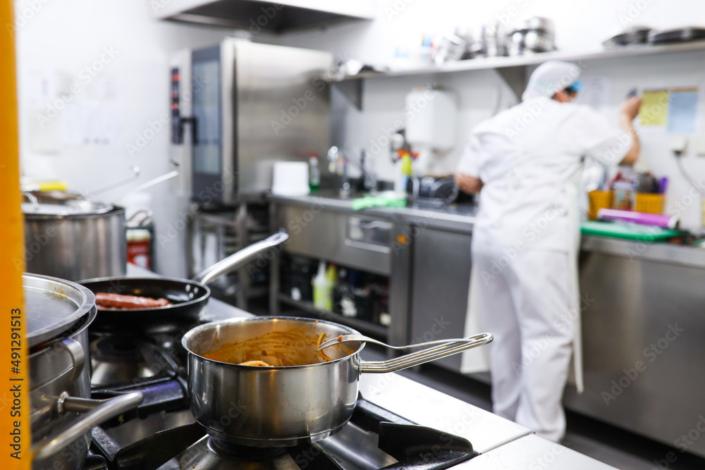 school kitchen in the middle of preparing the menu for the students who ...