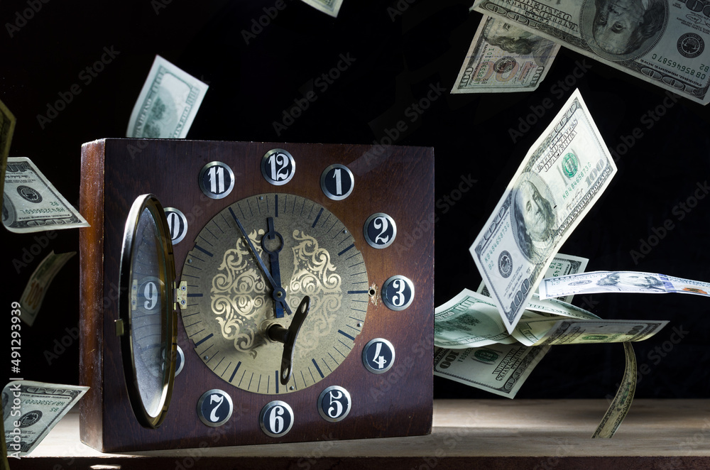 Desktop mechanical clock and money. Clock with arrows and floating ...