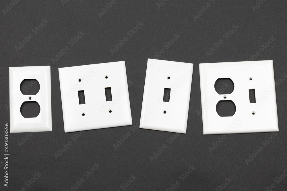 Collection of electrical face plates for outlets and switches in a flat ...