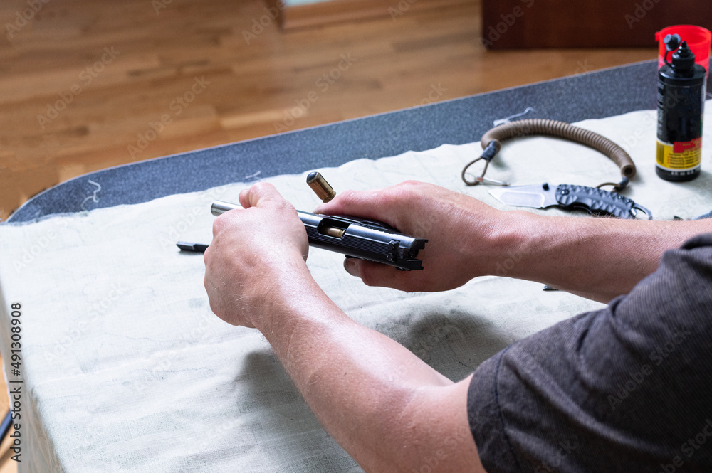 Reloading a pistol. The flight of a bullet from a pistol clip. Pistol ...