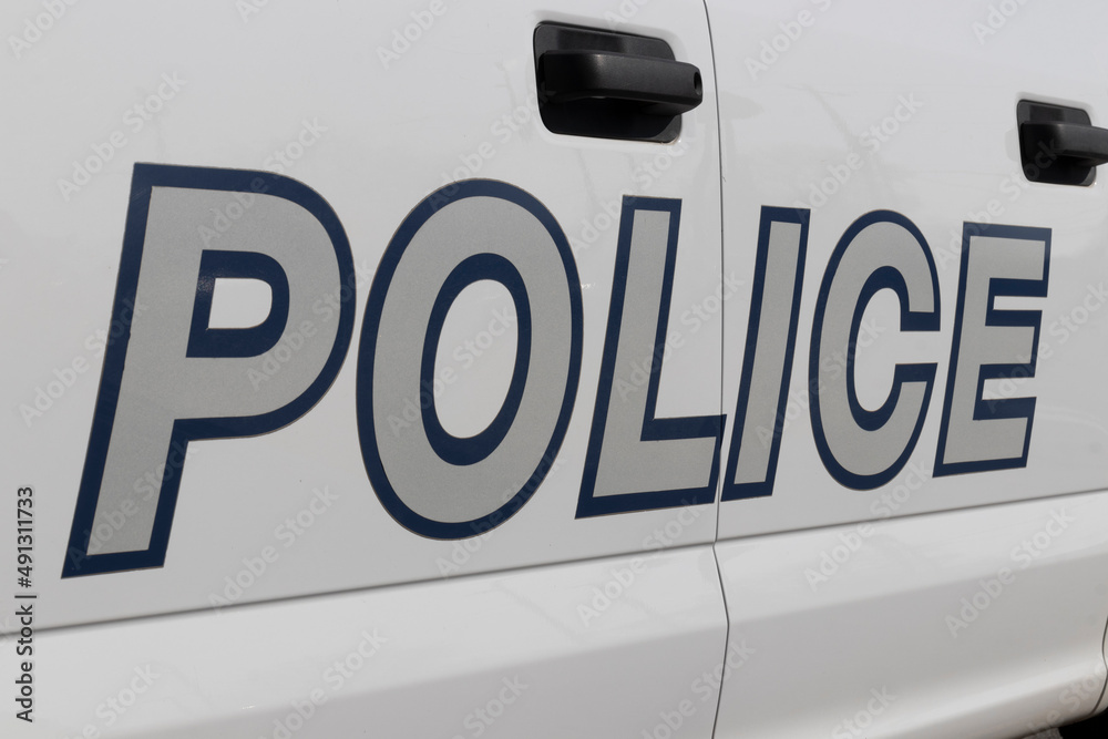 POLICE printed on the side of a police car in bold silver text with ...