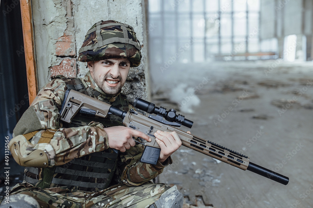 Military man in the form holds in the hands of a big rifle, looks like ...