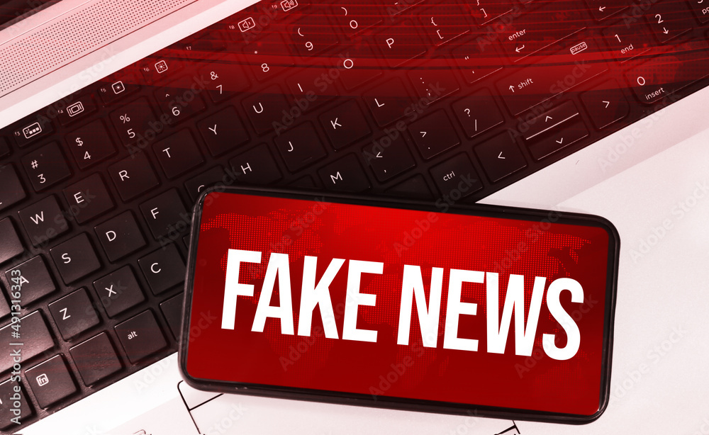 Fake News on Social Media and Mobile with Laptop in the Backdrop ...