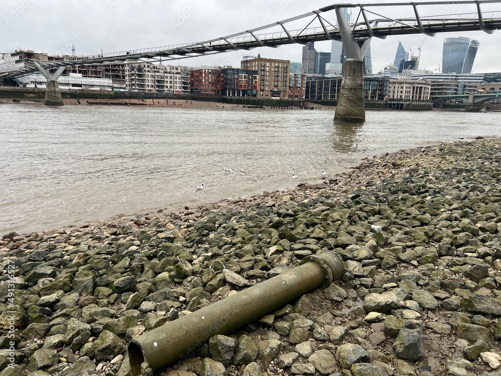 Landscape of the river Thames in London mud larking shore with rocks ...