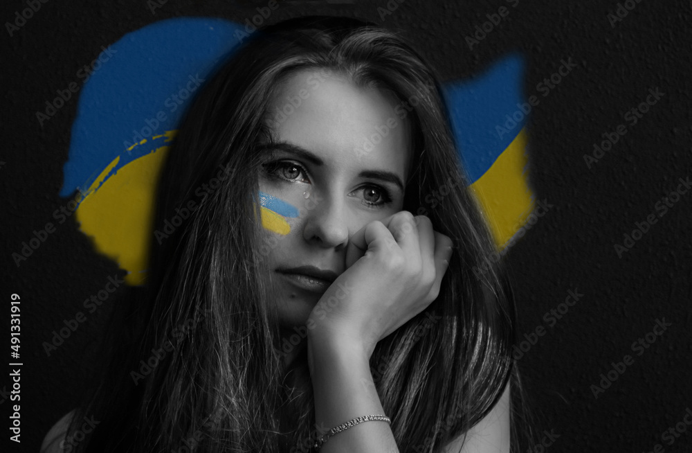 No war in Ukraine. Portrait of a girl against the background of the ...