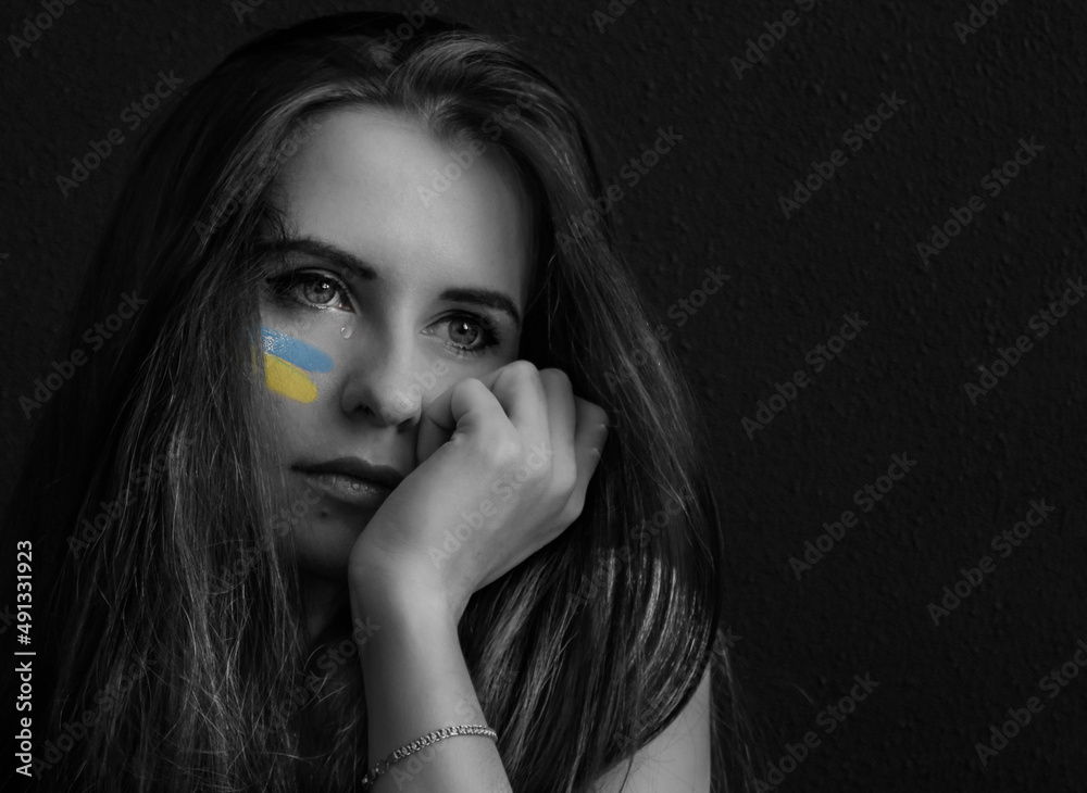 There is no war in Ukraine. Portrait of a girl covering her face with ...