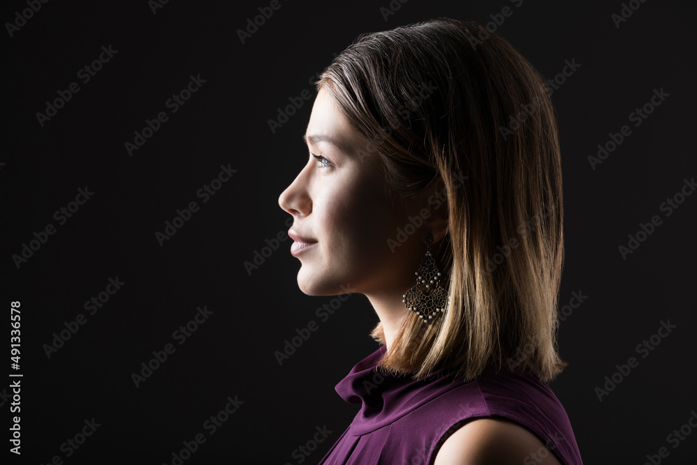 Profile of woman against black background Stock Photo | Adobe Stock