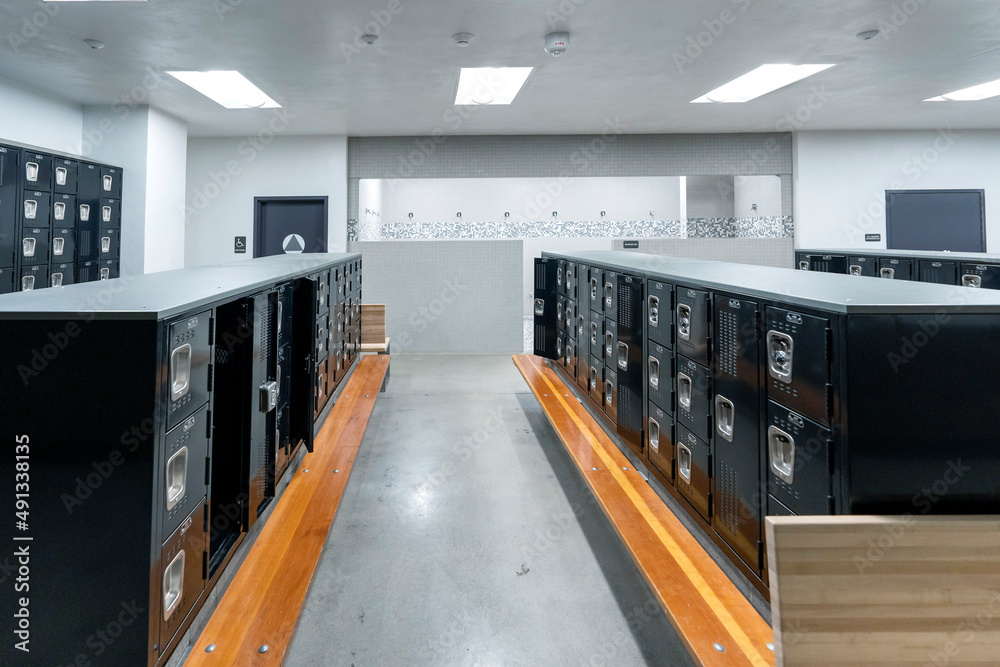 Locker room interior with lockers, benches, aisle Stock Photo | Adobe Stock