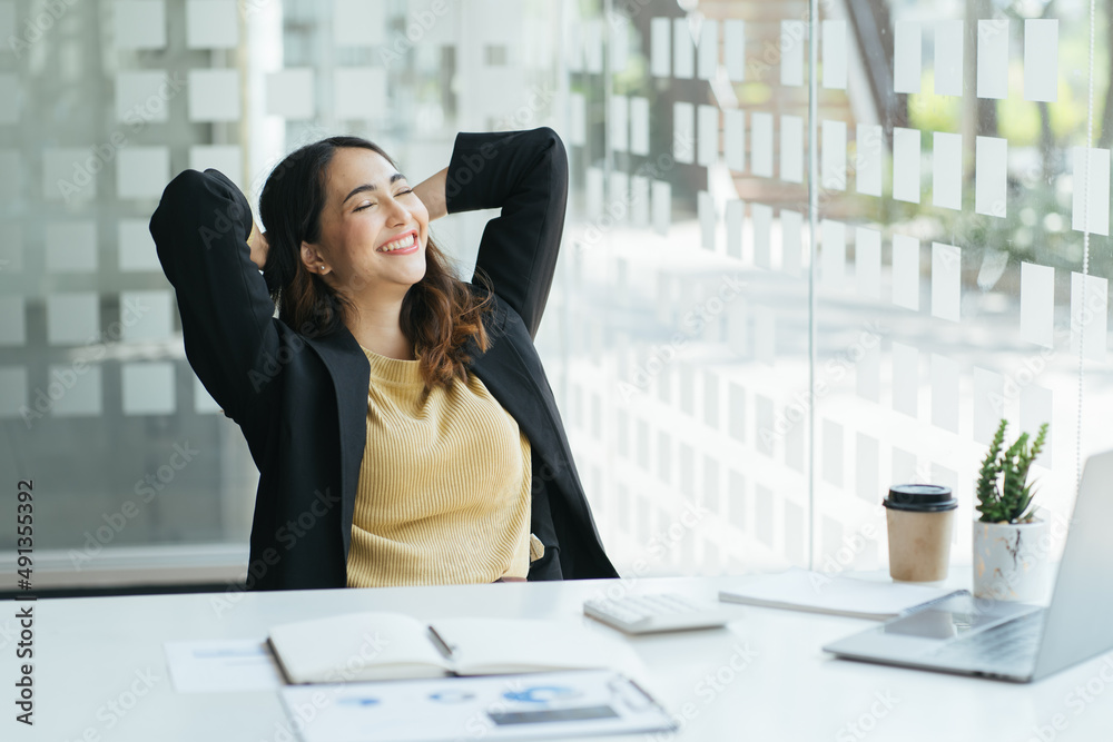 Carefree indian employee resting after busy fruitful workday leaned on ...
