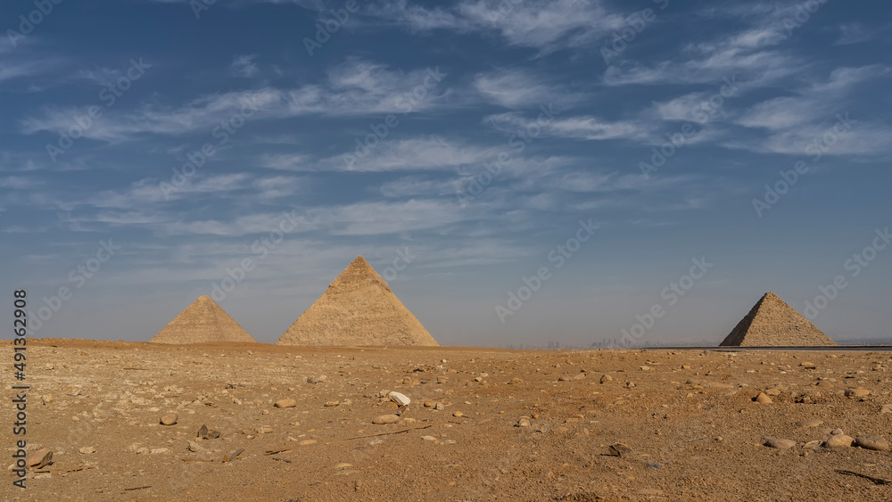 Three Great Pyramids Giza against blue sky and clouds. Stones are ...
