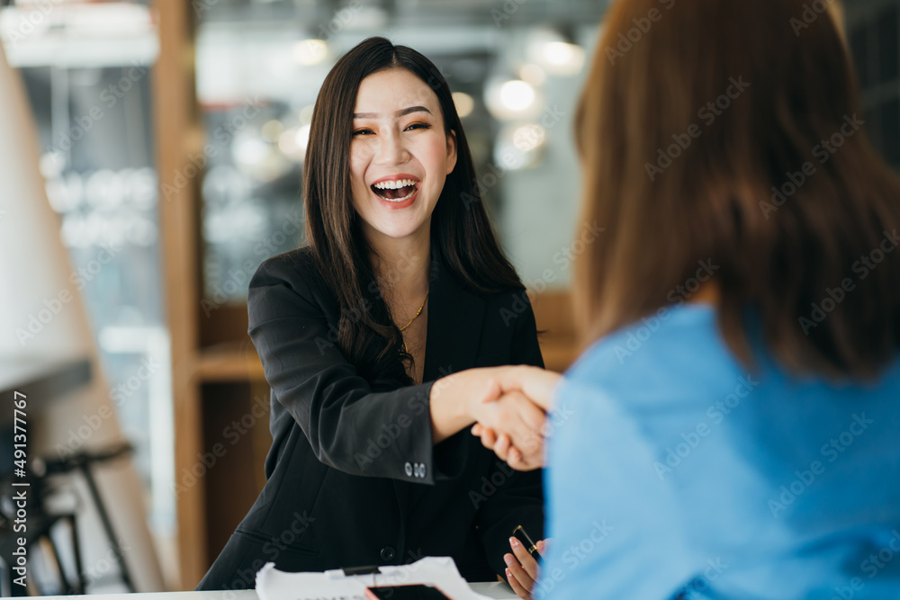 Foto de Portrait young Asian woman interviewer and interviewee shaking ...