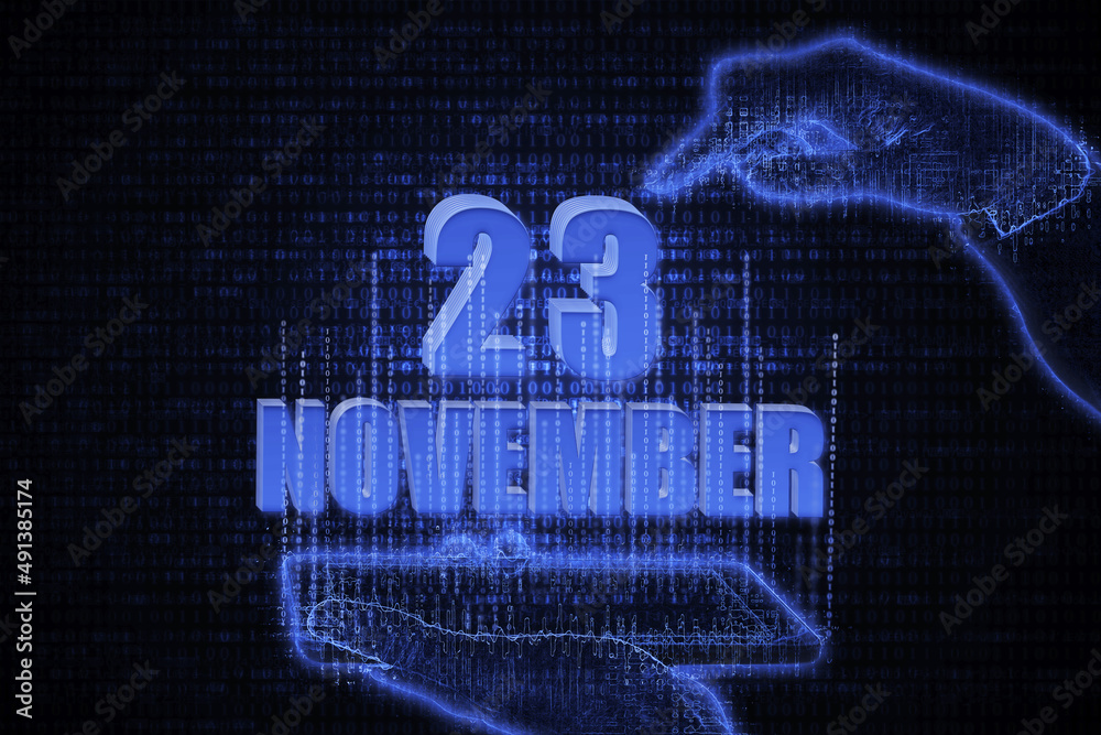 November 23rd. A hand holding a phone with a calendar date on a ...