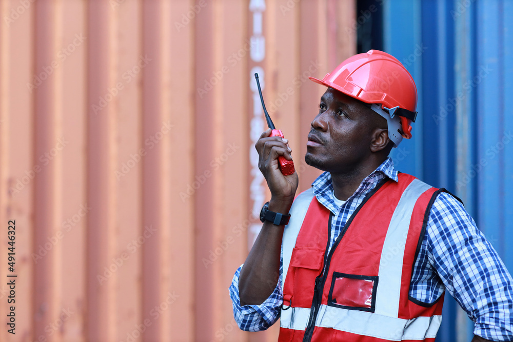 Foreman engineer using walkie talkie radio control loading containers ...