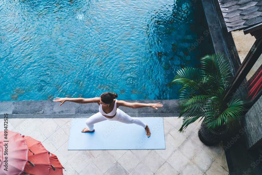 Top view of woman in track suit stretching in yoga pose breathing ...