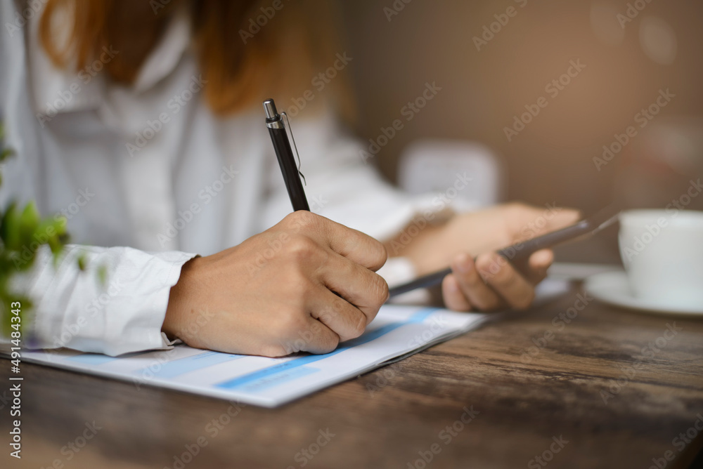 Hand of Planner write meeting agenda at Calendar, use smartphone to ...