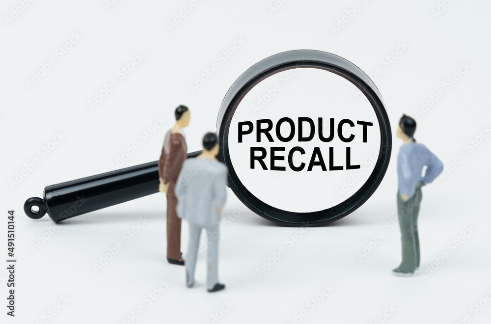 On a white background, figures of businessmen and a magnifying glass ...