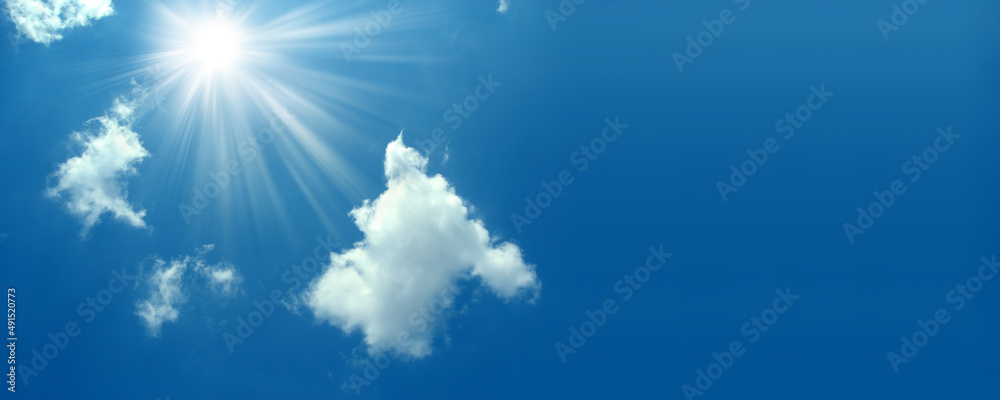 A blue sky with sun and clouds background. Shining sun on blue sky with ...