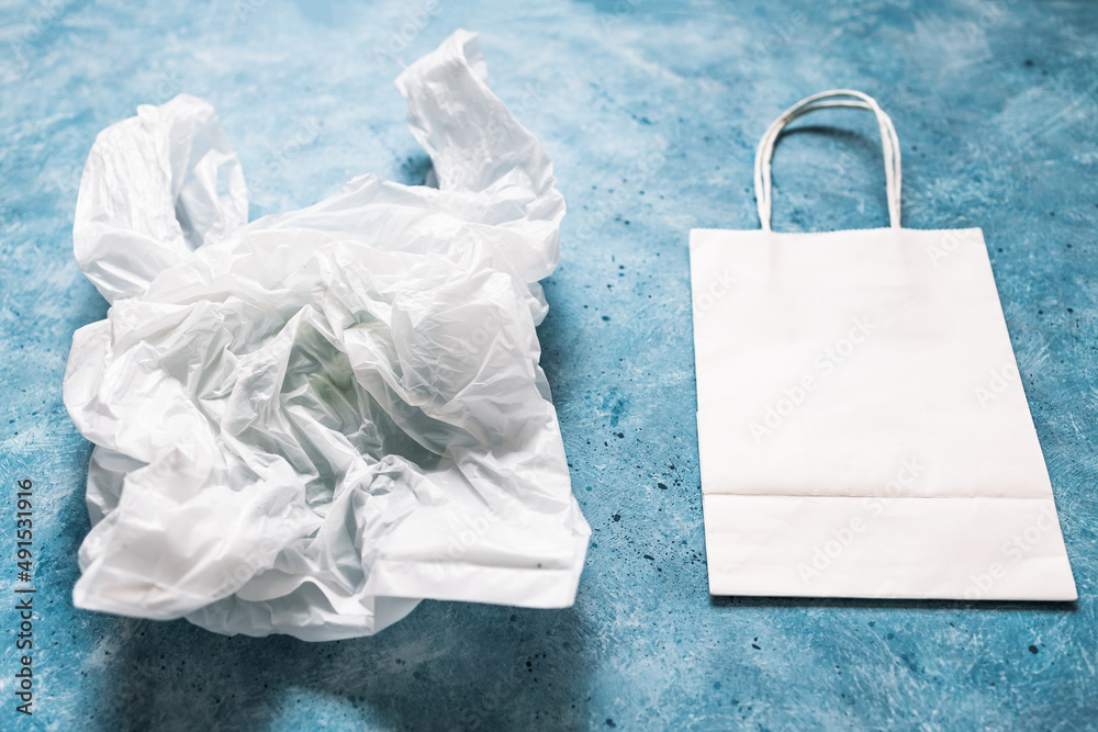 single use plastic bag next to paper one, plastic pollution and ...