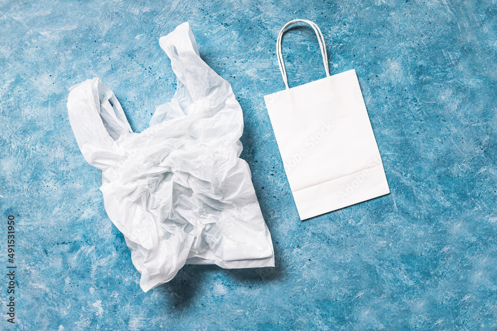 single use plastic bag next to paper one, plastic pollution and ...