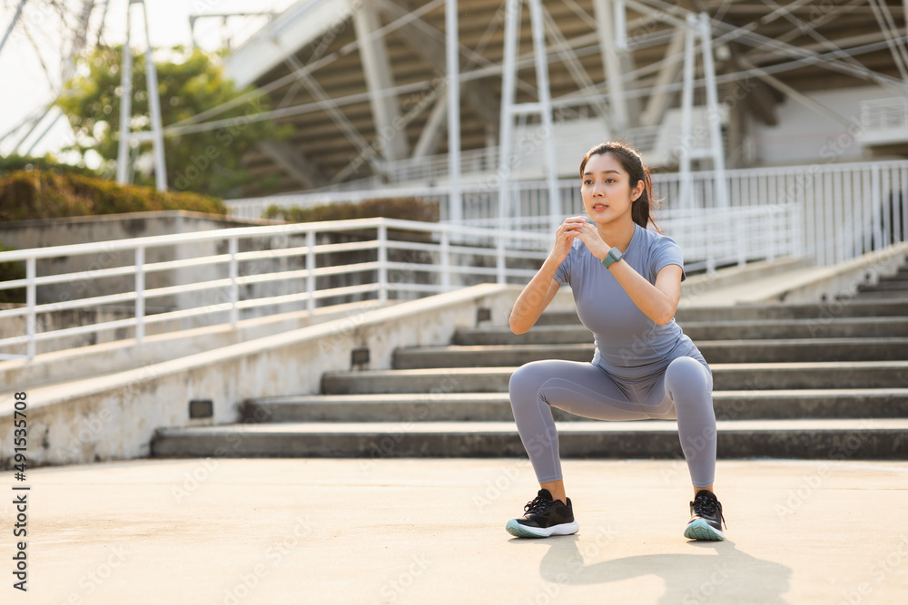 Beautiful fitness asian woman doing squat sit up exercise workout at ...