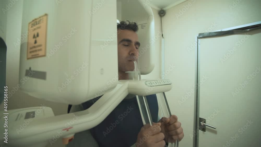 Patient mouth and dental x-ray machine. The moment of x-ray of the ...