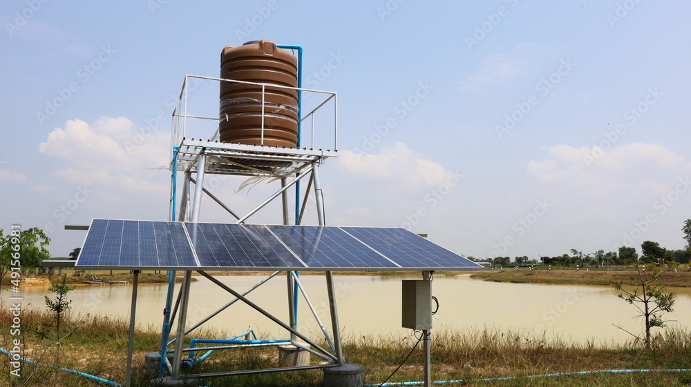 Solar panels and water tanks. Close-up of photovoltaic cells for ...
