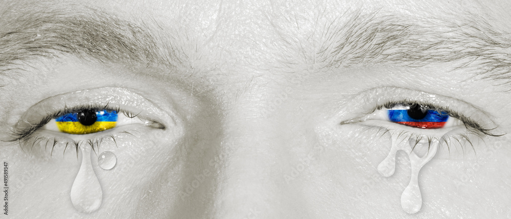 Crying eyes with the Russian flag and Ukrainian flag in irises on black ...