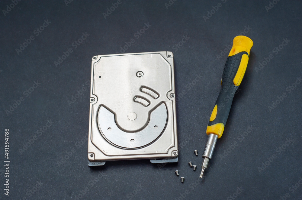 Engineer fixing broken computer hard disc. Electronic repair shop ...