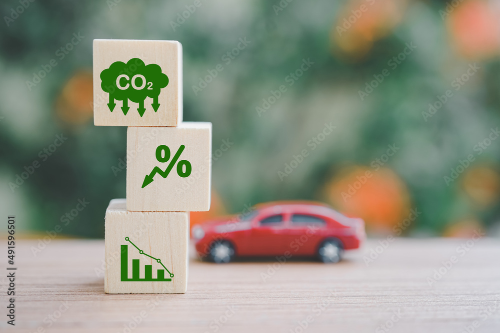 stack of wooden block with co2 reduction icon concept and blurred ...