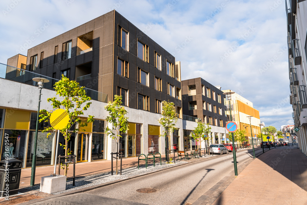 Modern residential buildings with shops on the ground level along a ...