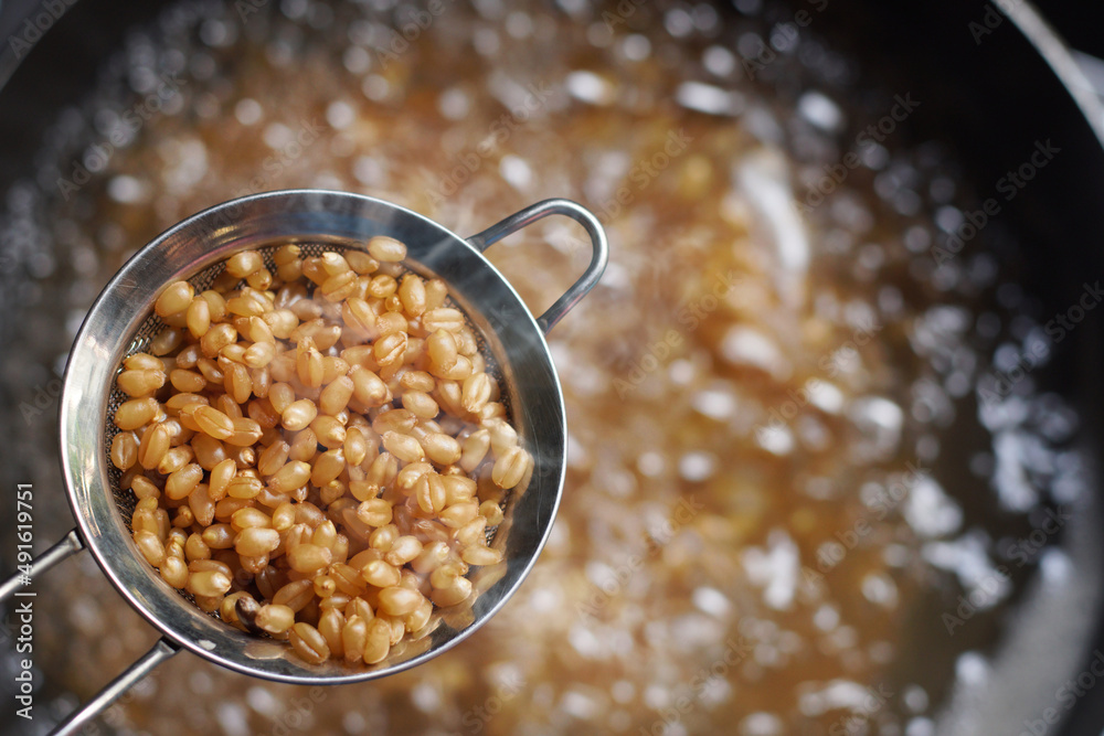 Boiling wheat rice ( Khao Sa Lee) in culture market at Thailand ...