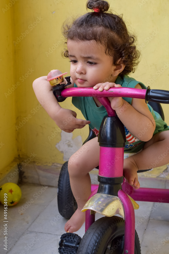 Cute little boy Shivaay driving cycle at home balcony during summer ...