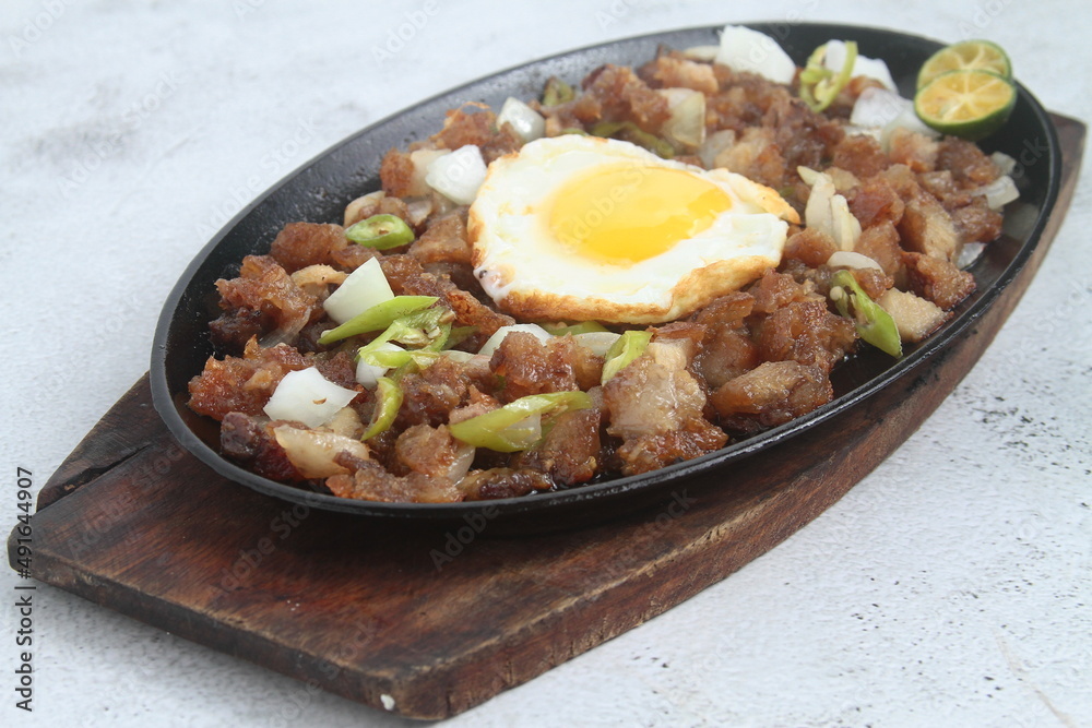 Freshly made Filipino food called Pork Sisig or chopped pork served in ...