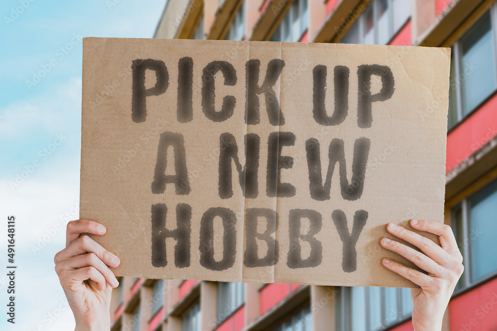 The phrase " Pick up a new hobby " on a banner in men's hands with ...