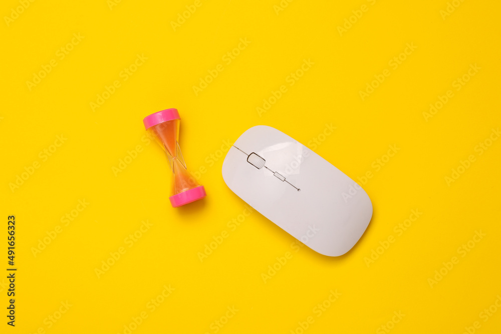 Pc mouse with hourglass on yellow background. Top view Stock Photo ...