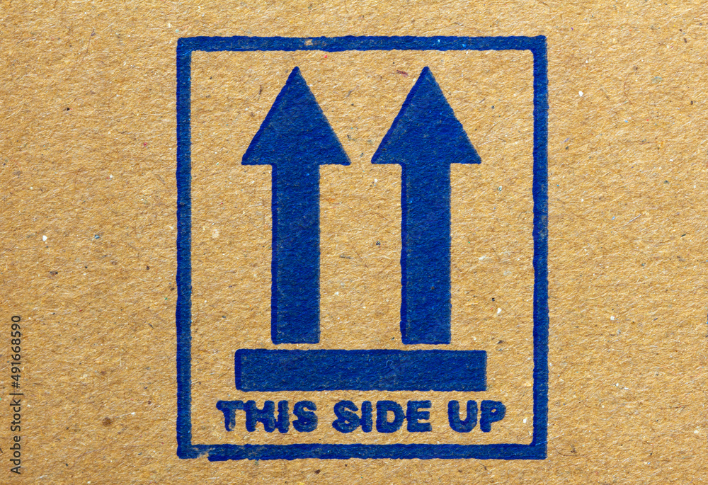 This Side Up sign in a packaging box. Arrow mark indicating correct way ...