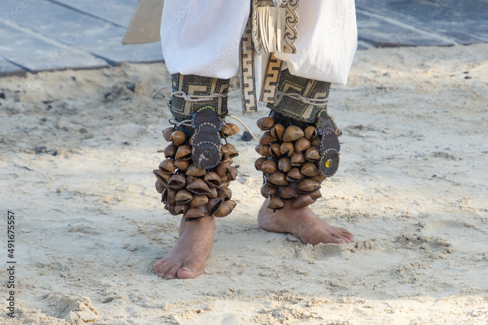 Feet of indigenous man dancing in traditional costume. Traditional ...