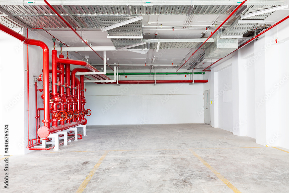 Parking garage interior, industrial building, hydrant with water hoses ...
