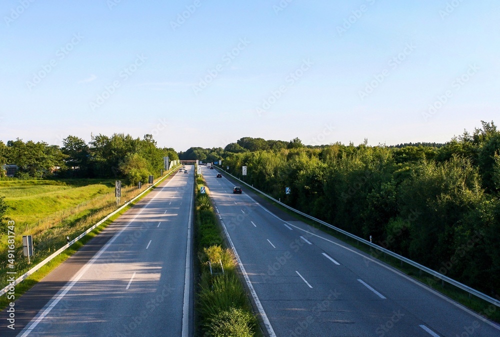 Perspective view of highway in Itzehoe, Germany with trees and clear ...