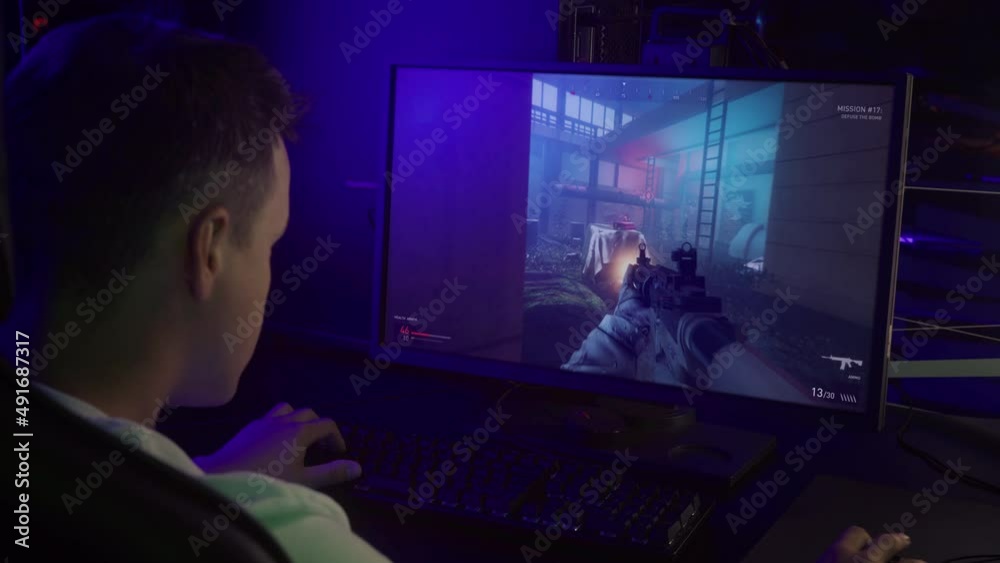 Gamer is using military weapons in the modern computer shooter game ...