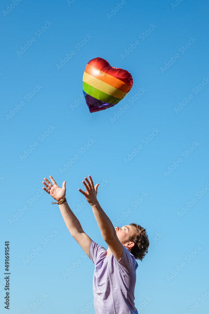 Transgender releasing balloon with LGBT flag in air Stock Photo | Adobe ...